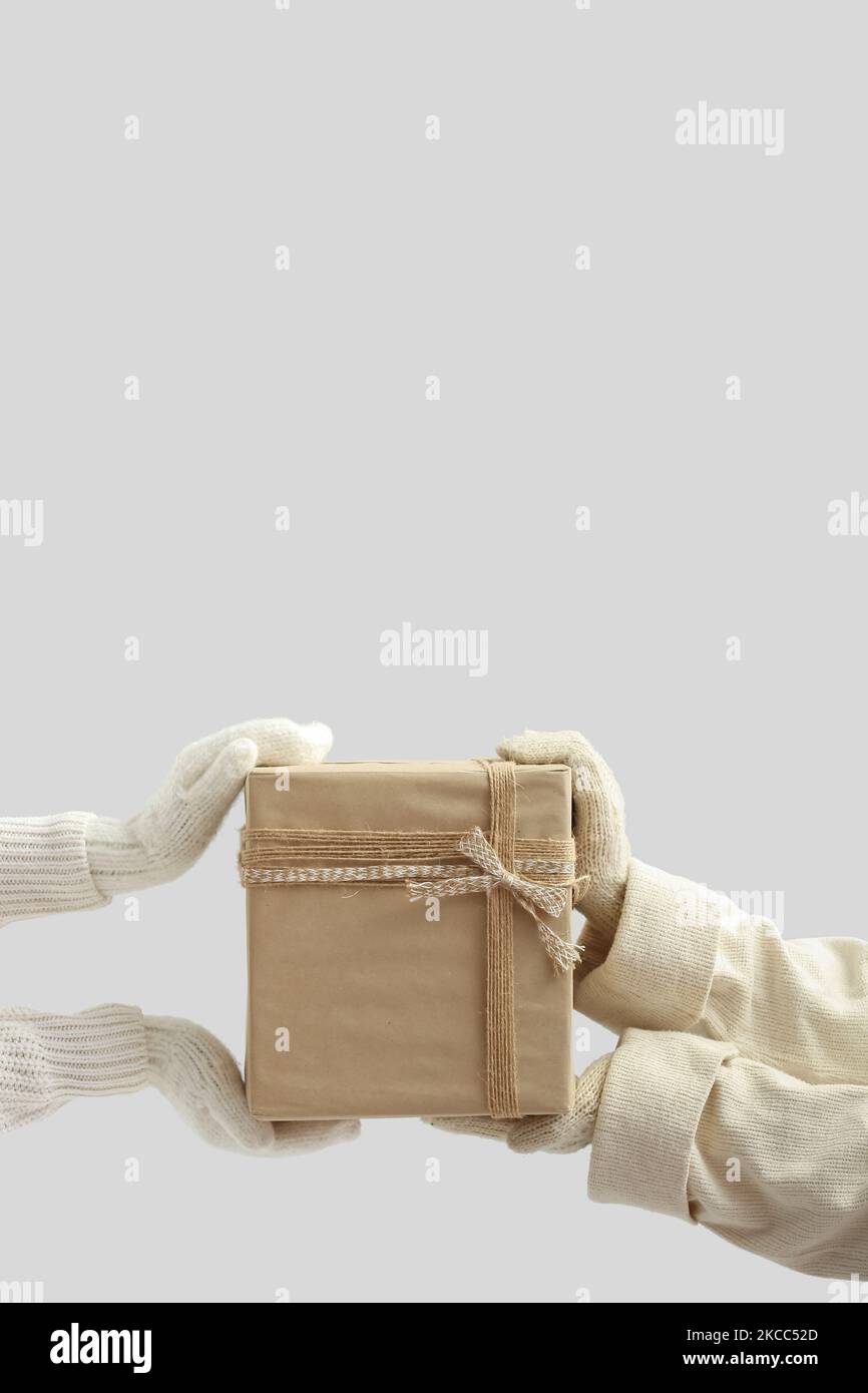 Women with Christmas gift box on grey background Stock Photo - Alamy