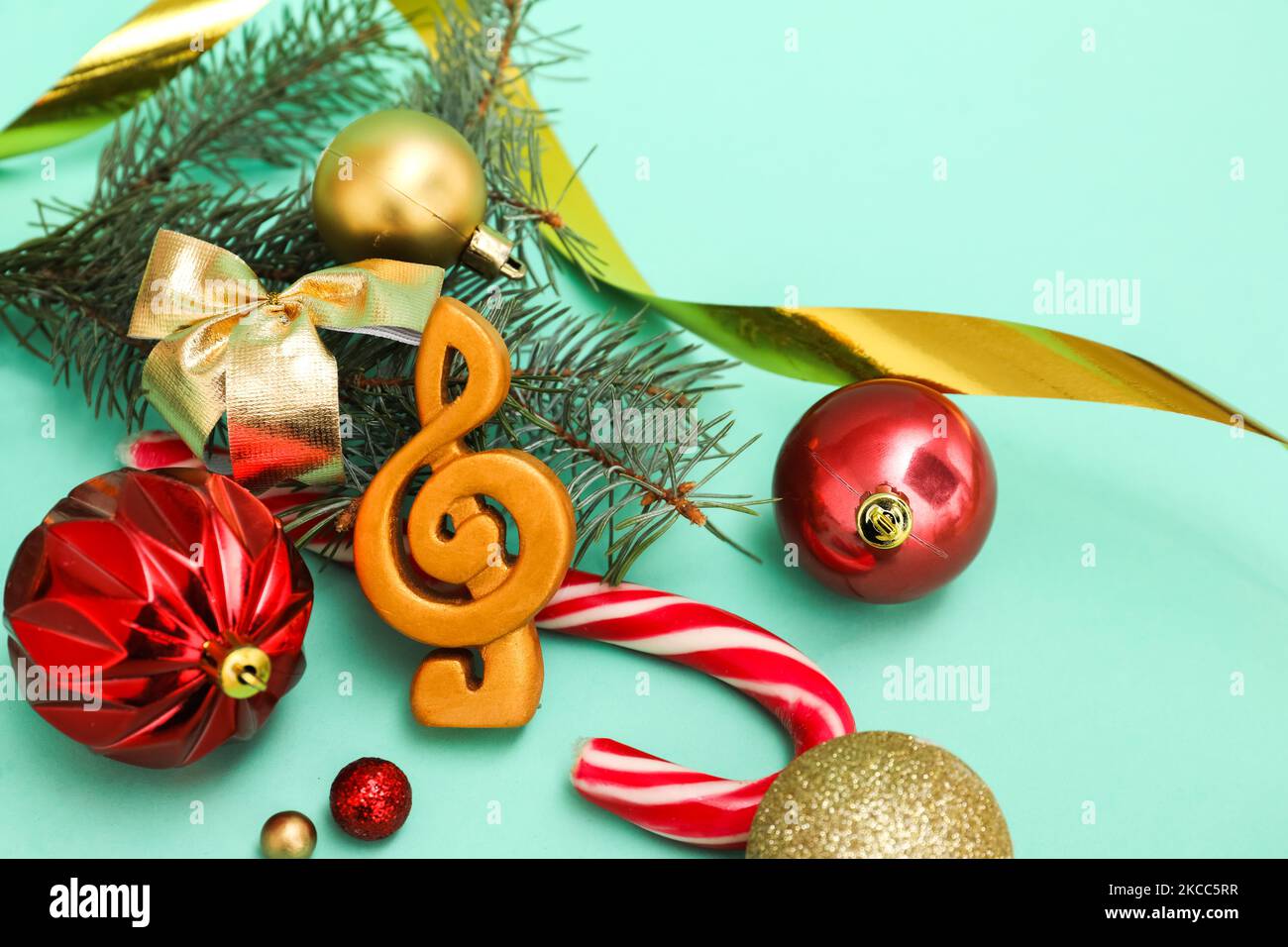 Treble clef with Christmas branches and decor on green background ...