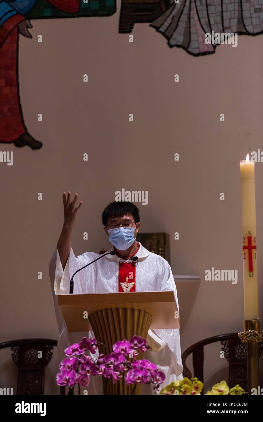 A priest exhorts his faithful in the closing moments of his homily ...
