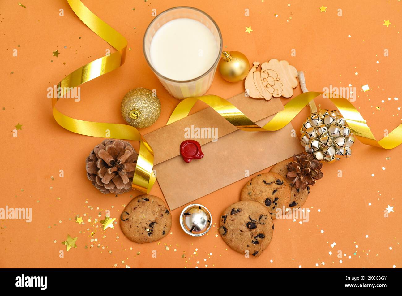Letter to Santa with glass of milk, cookies and Christmas decor on ...