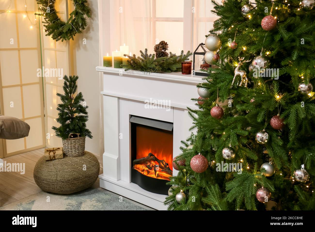 Interior of living room with fireplace, Christmas trees and window ...