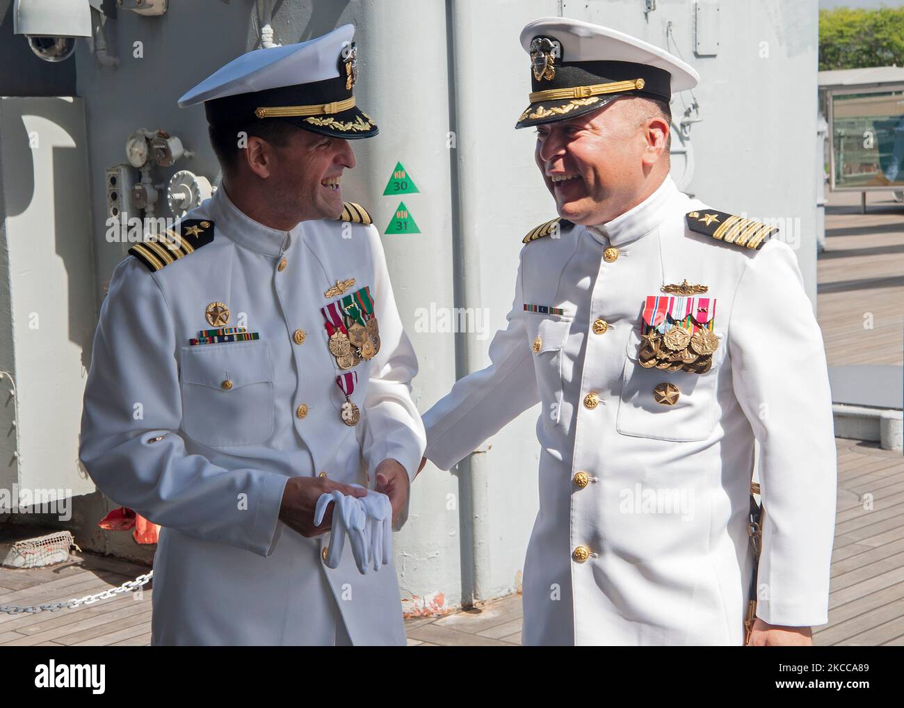 Commanding officers exchange words during a change of command ceremony ...