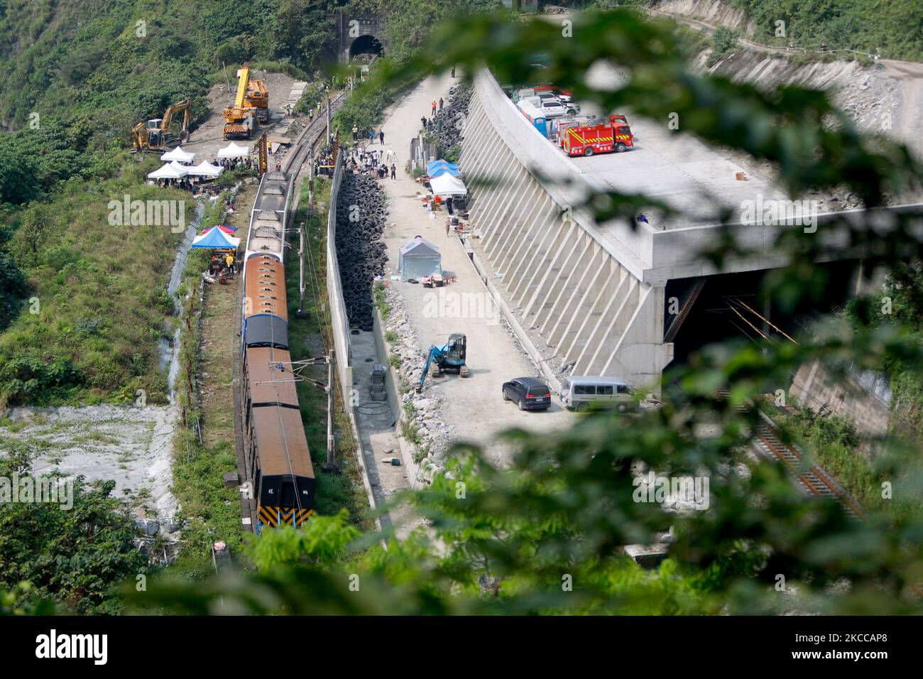 Views of the damaged train carriages being lifted and removed from ...