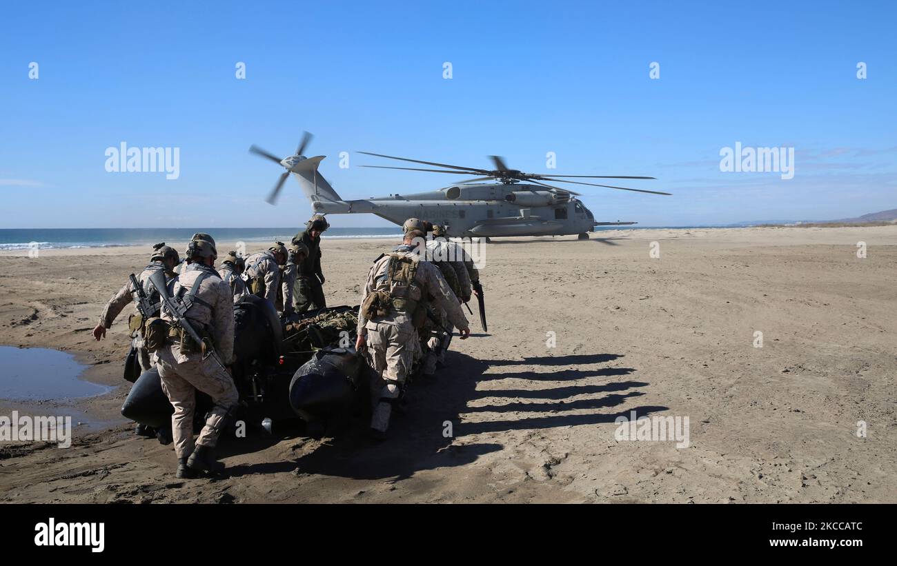 U.S. Marines load a combat rubber raiding craft for helocast operations ...