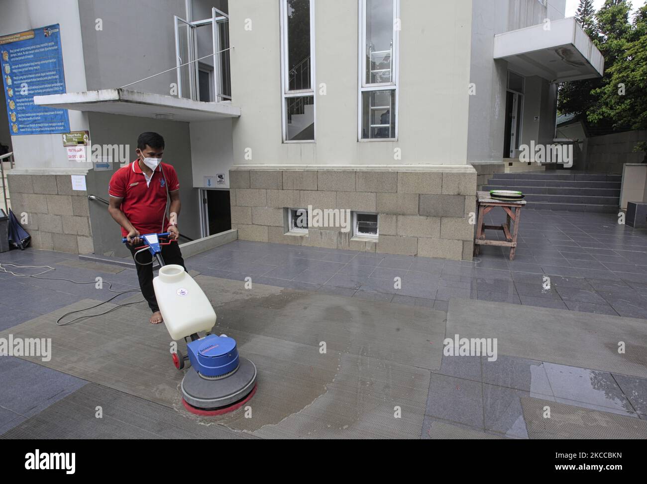 A worker wash the floor of a Mosque in Bogor, Indonesia on April 7 ...