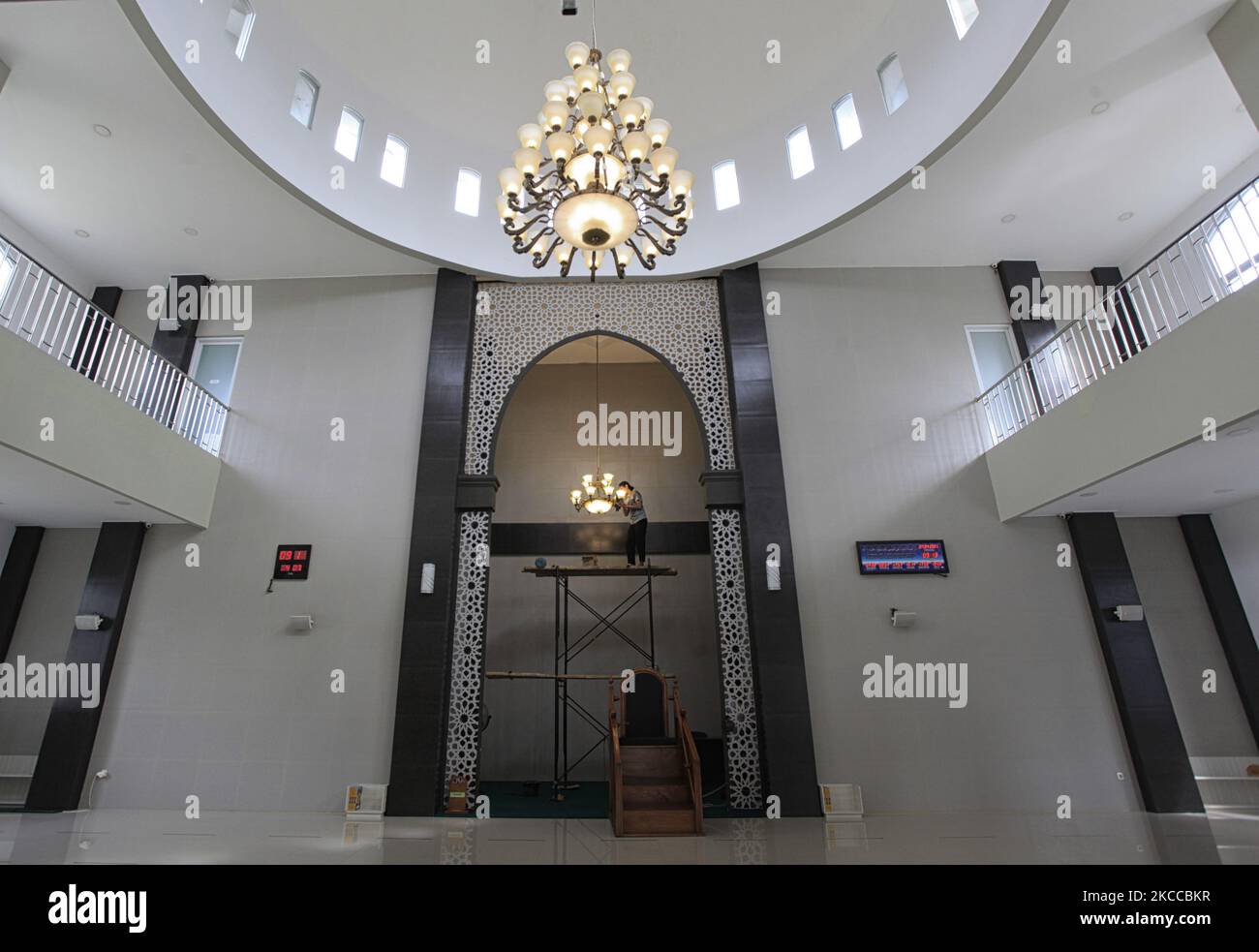 A worker check a lamp at a Mosque in Bogor, Indonesia on April 7, 2021 ...