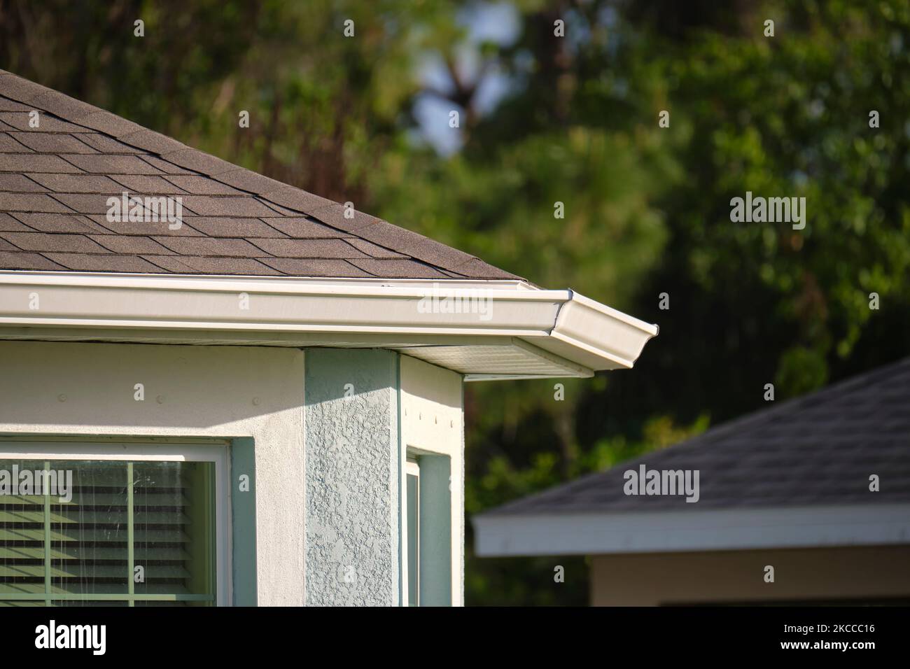 Closeup of house roof top covered with asphalt or bitumen shingles ...