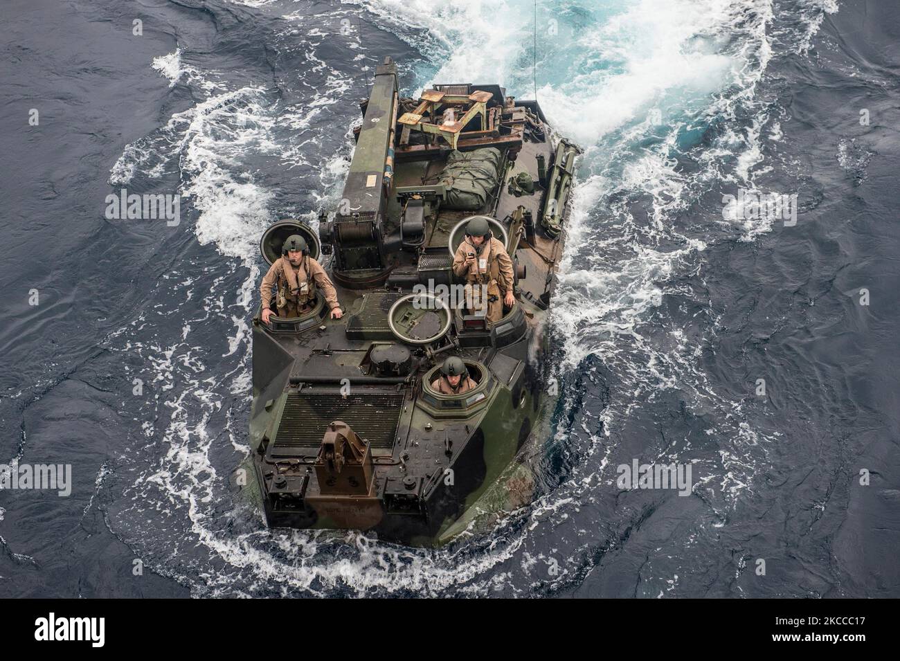 An amphibious assault vehicle prepares to enter the well deck of USS ...
