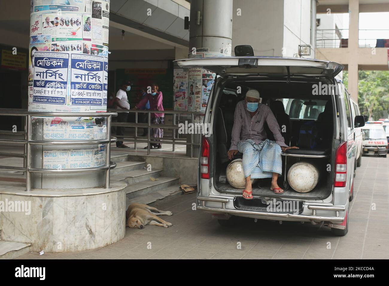 A Covid-19 patient wait inside an ambulance in front of Dhaka Medical College Hospital for ...