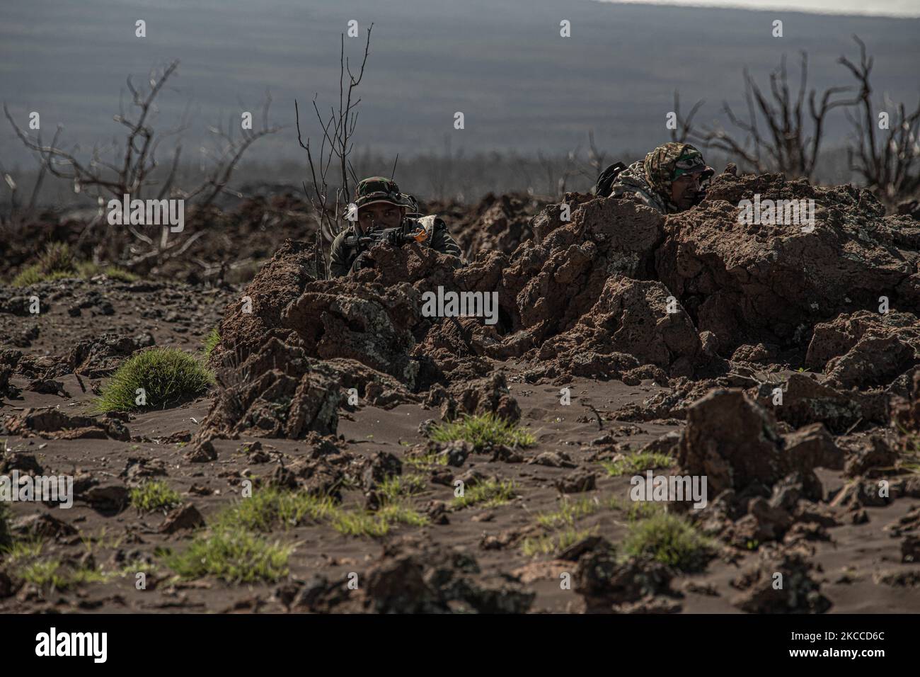 TNI Soldiers playing the opposing force returns simulated fire on the ...