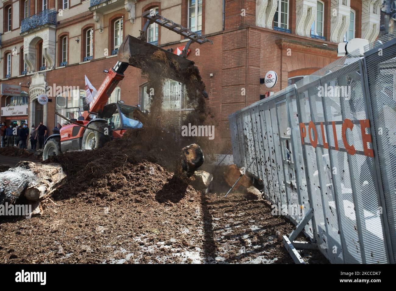 A farmer discharges manure near riot police. Several hundreds of ...