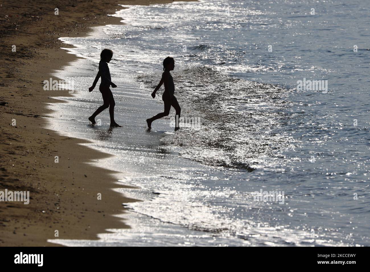 People swim at the beach on April 10, 2021 in Singapore. (Photo by ...