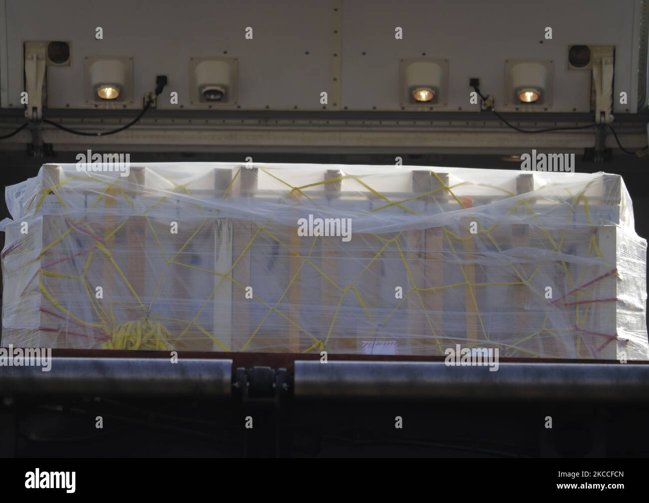 Workers of the international courier company DHL unload a batch of ...