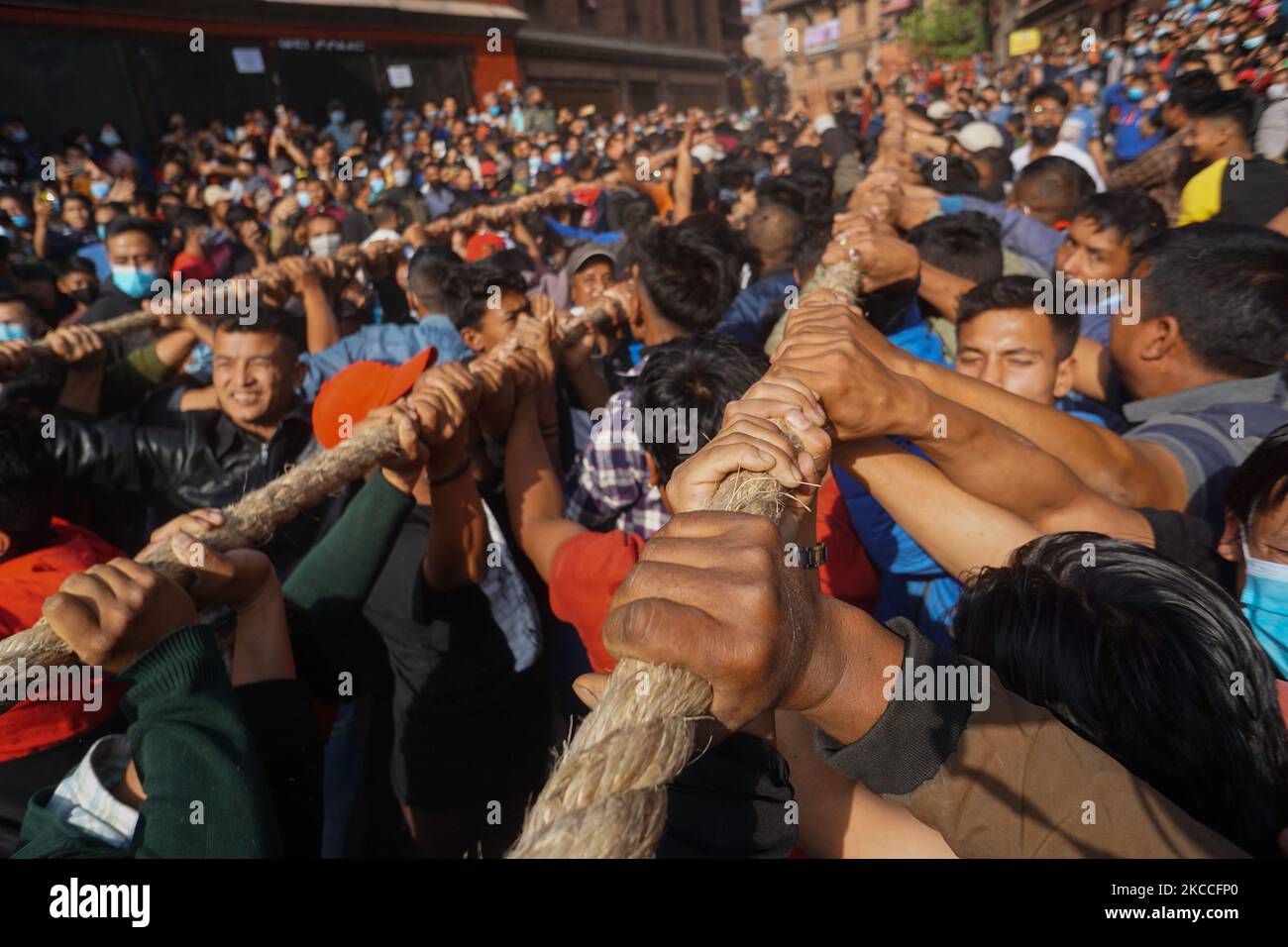 Devotees pull a chariot carrying an idol of Hindu god Bhairav during ...