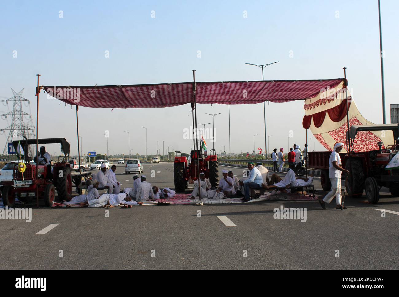 Farmers sit in a tent during a 24-hour blockade of KMP Expressway ...