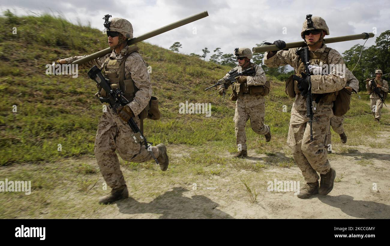 U.S. Marines rush to a wire trap to set up a Bangalore charge Stock ...