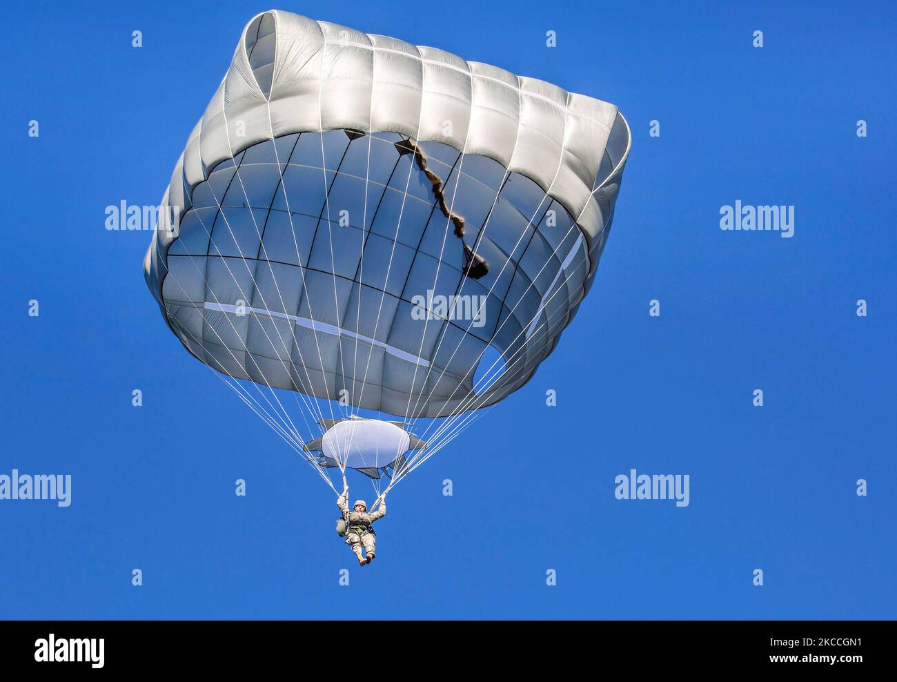 U.S. Army Soldier conducting helicopter jump training over Alaska Stock ...