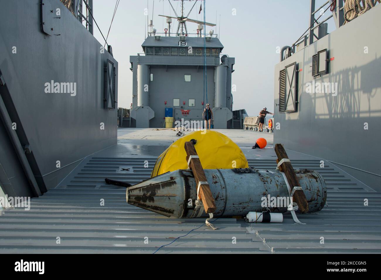 Explosive ordnance disposal technicians recover an inert training ...