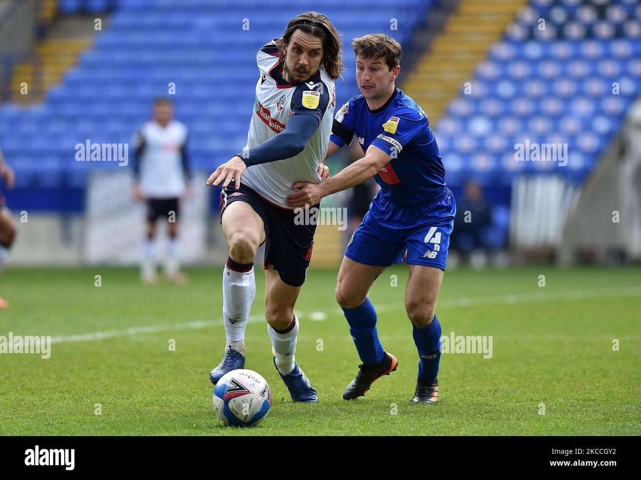 Jordan Williams of Bolton Wanderers tussles with Josh Falkingham of ...