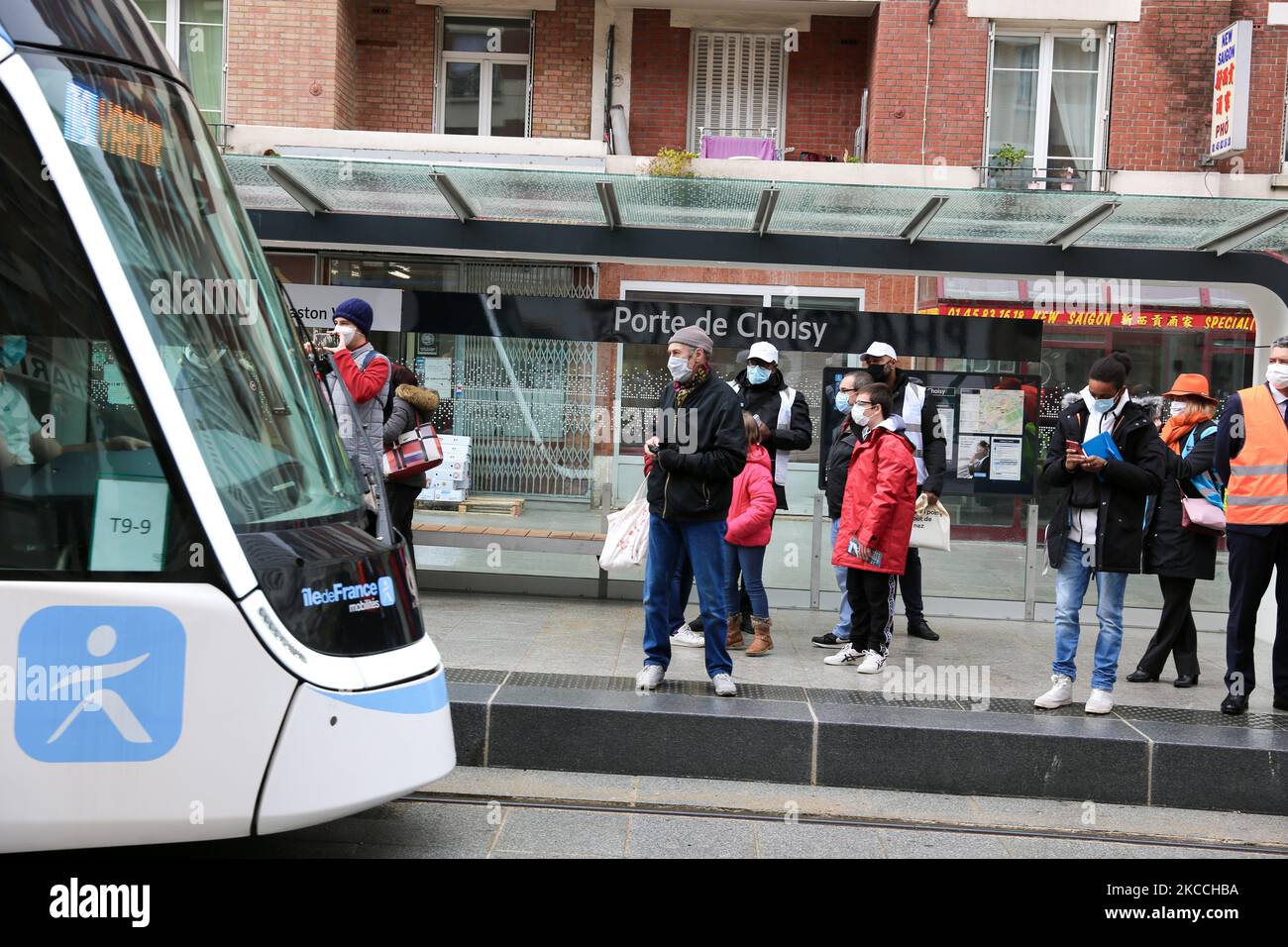 People attend the new tramway train on the opening day of the T9 tram ...