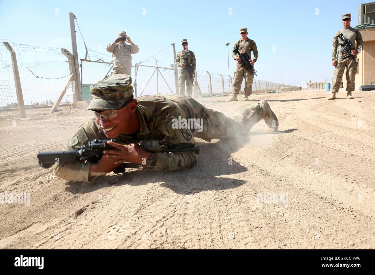 A U.S. Army soldier smiles as he demonstrates how to high crawl with ...
