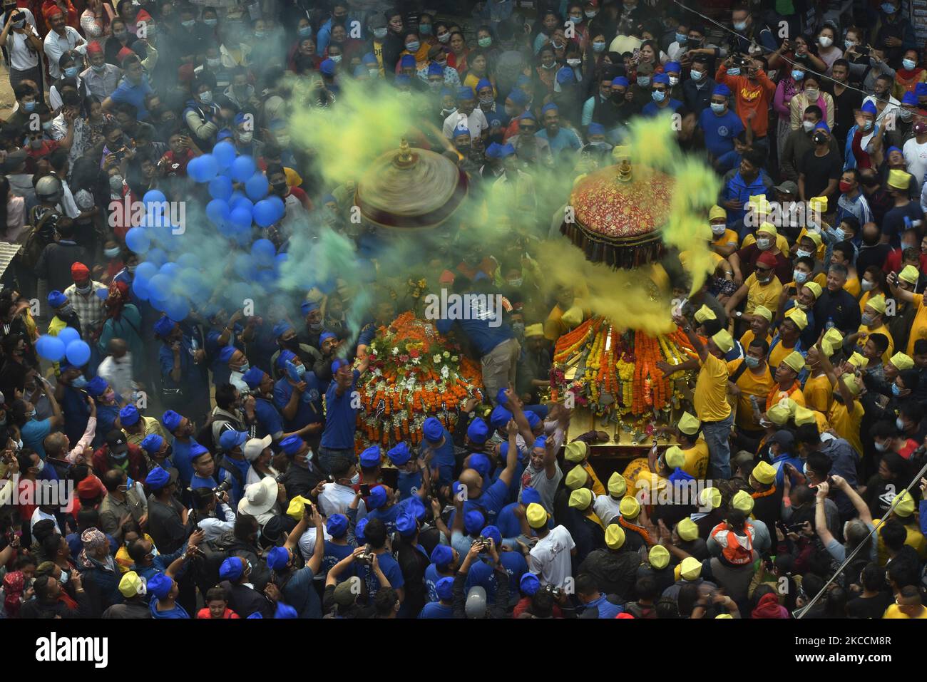 Nepalese devotees fire colorful smokes from the chariot during ...