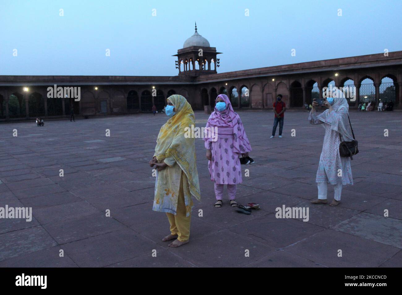 Women wearing mask click pictures of each other at the historic Jama ...