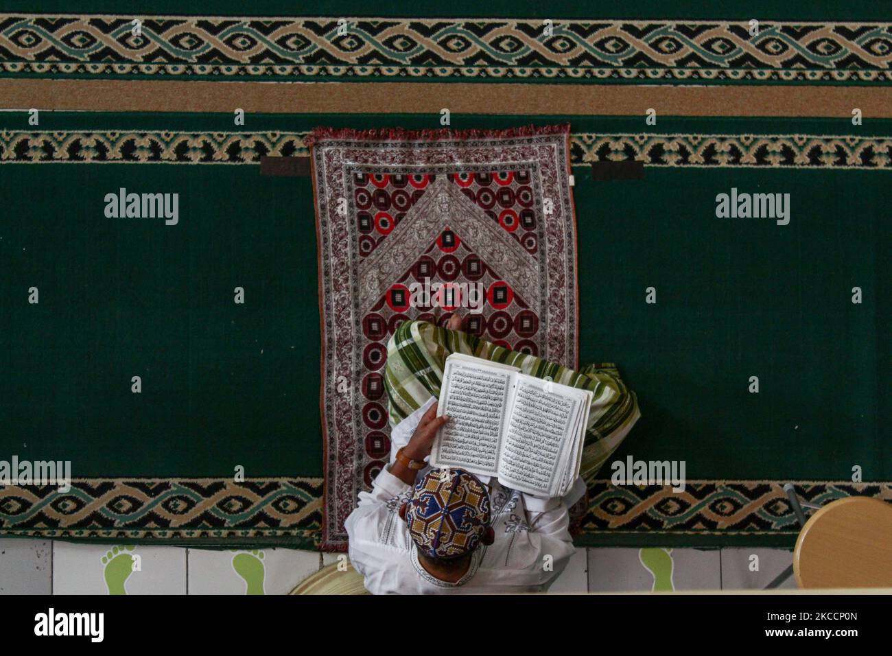 A muslim man reads the Koran during the holy month of Ramadan at Nurul ...
