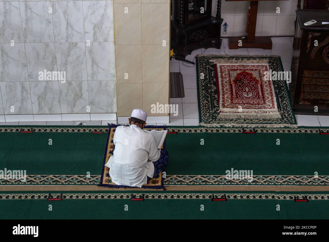 A muslim man reads the Koran during the holy month of Ramadan at Nurul ...