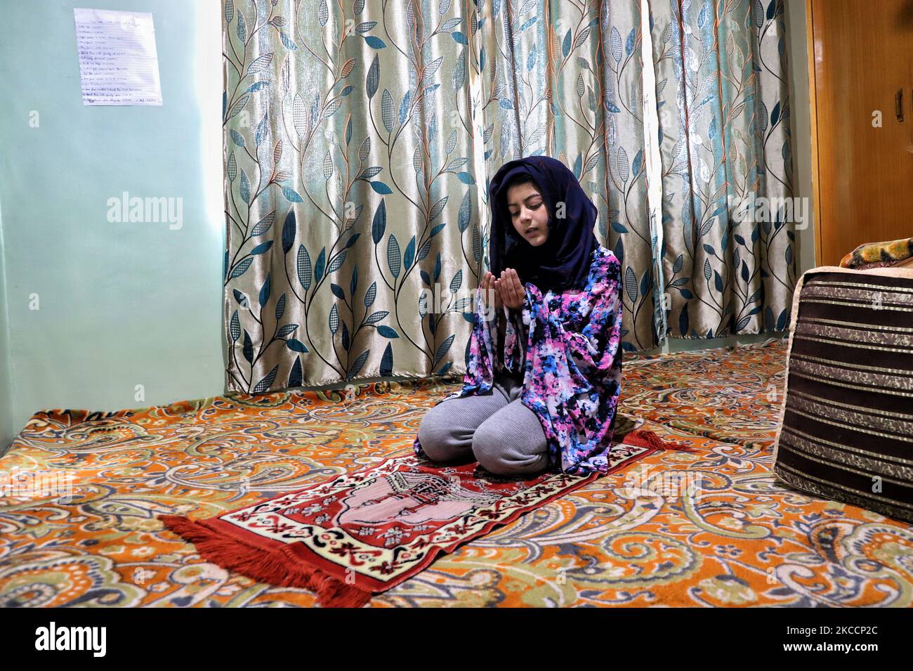 A Girl prays on the 1st day of the Holy month of Ramadan at her home ...