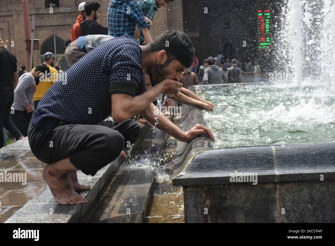 A Kashmiri man performs ablution on the first day of Ramadan in Kashmir ...
