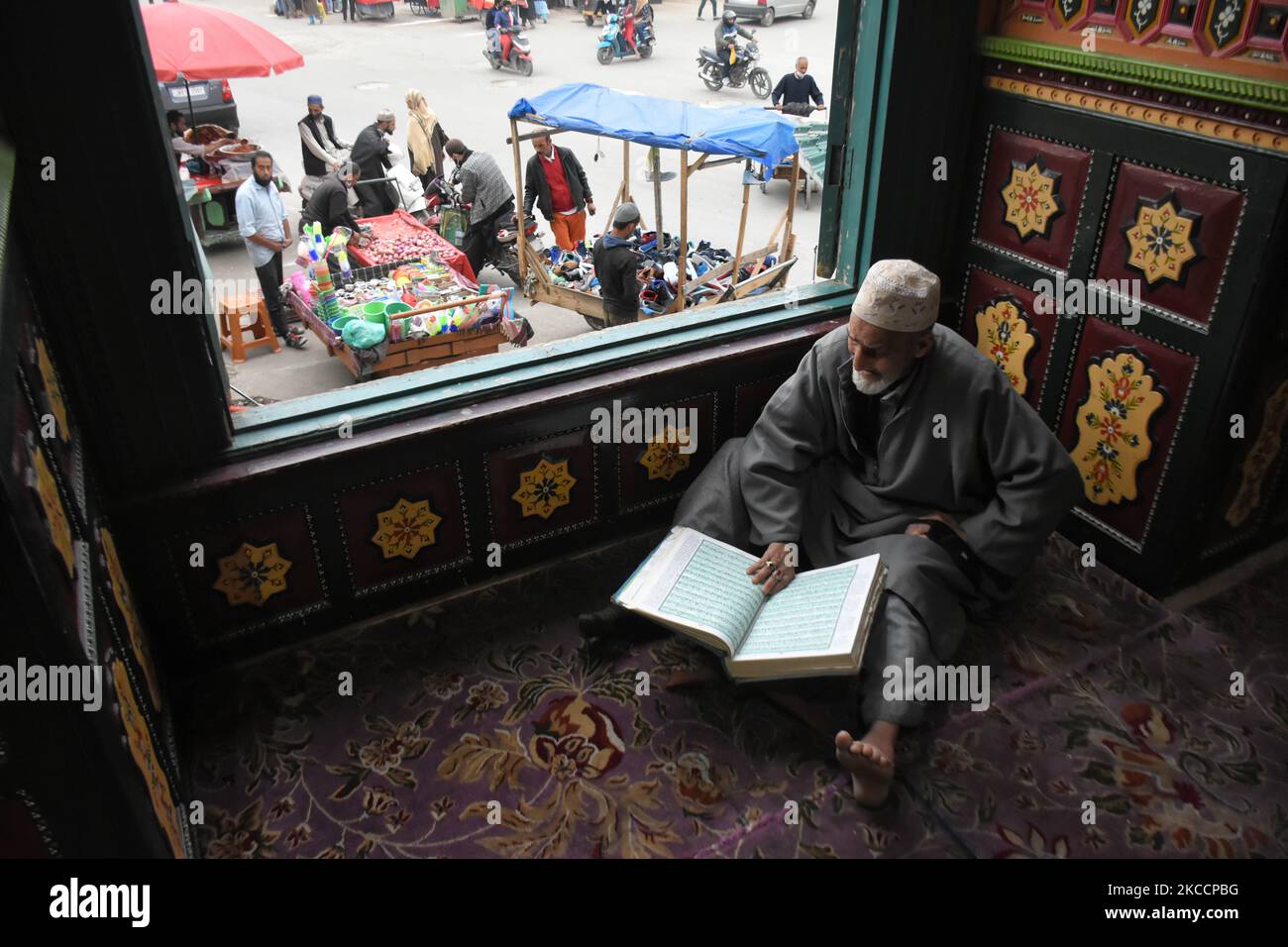 A Kashmiri man reads Holy Quran on the first day of Ramadan inside a ...