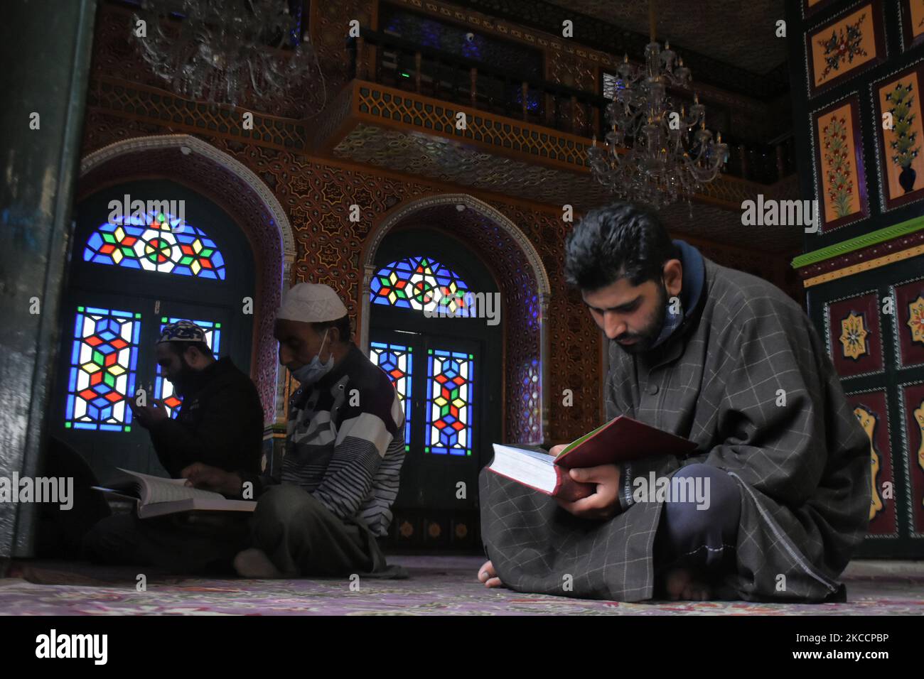 Kashmiri muslims read Holy Quran on the first day of Ramadan inside a ...