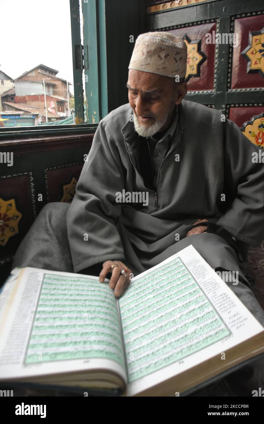 A Kashmiri man reads Holy Quran on the first day of Ramadan inside a ...