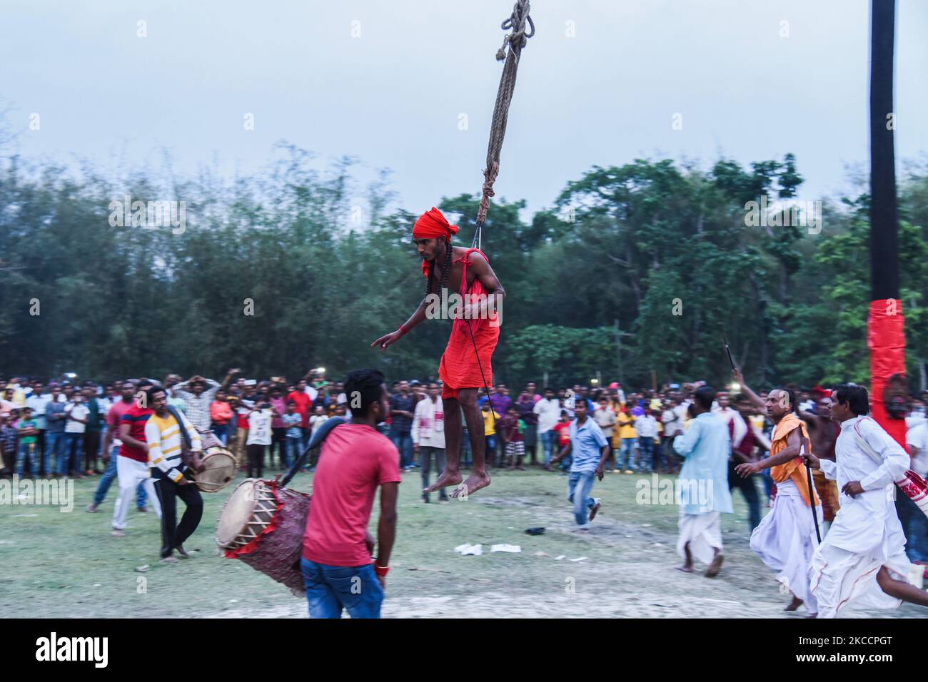 Hindu devotee pierced with iron hook, moved around a bar with a long ...