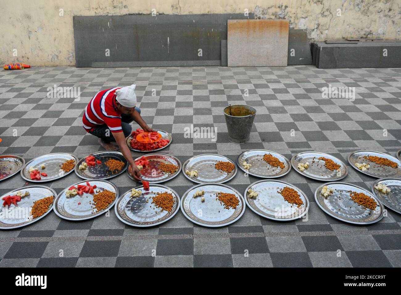 A man distributes various fruits and food to break the Iftar fast for ...