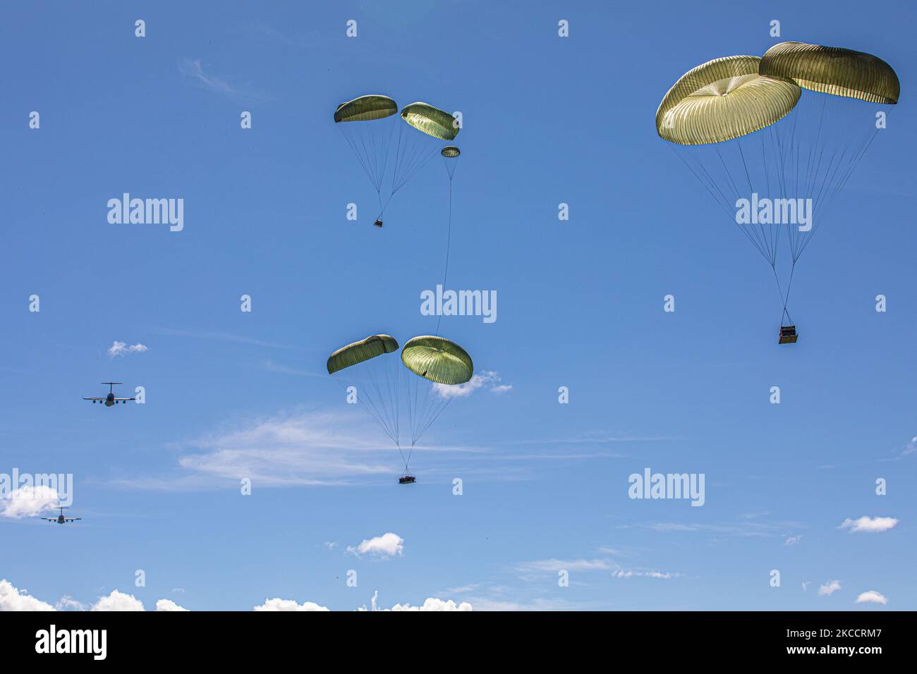 U.S. Air Force C-130s conduct an airdrop on Pohakuloa Training Grounds ...