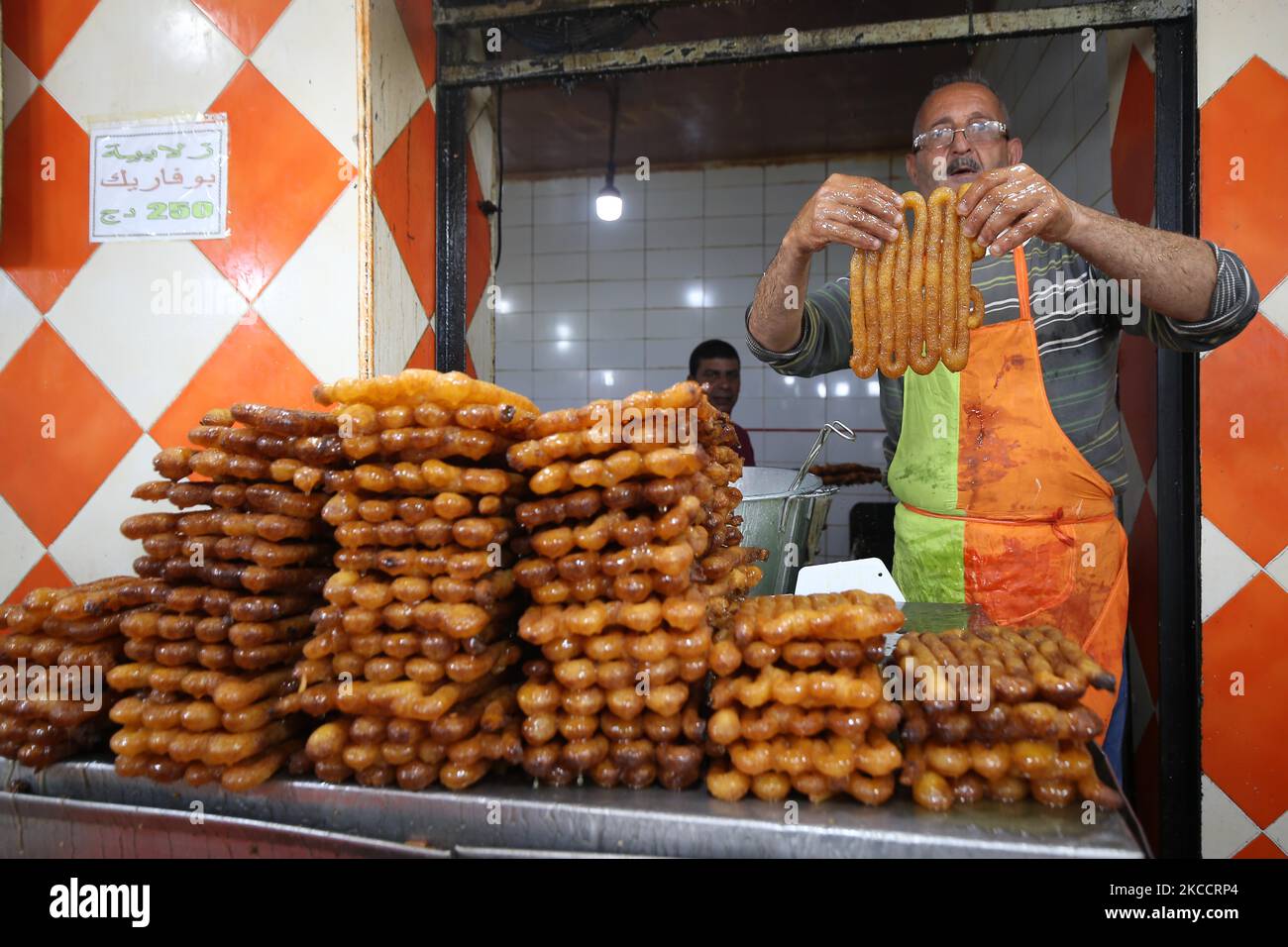 A man from Algeria sells a special dessert known as "zalabia" and lemon ...
