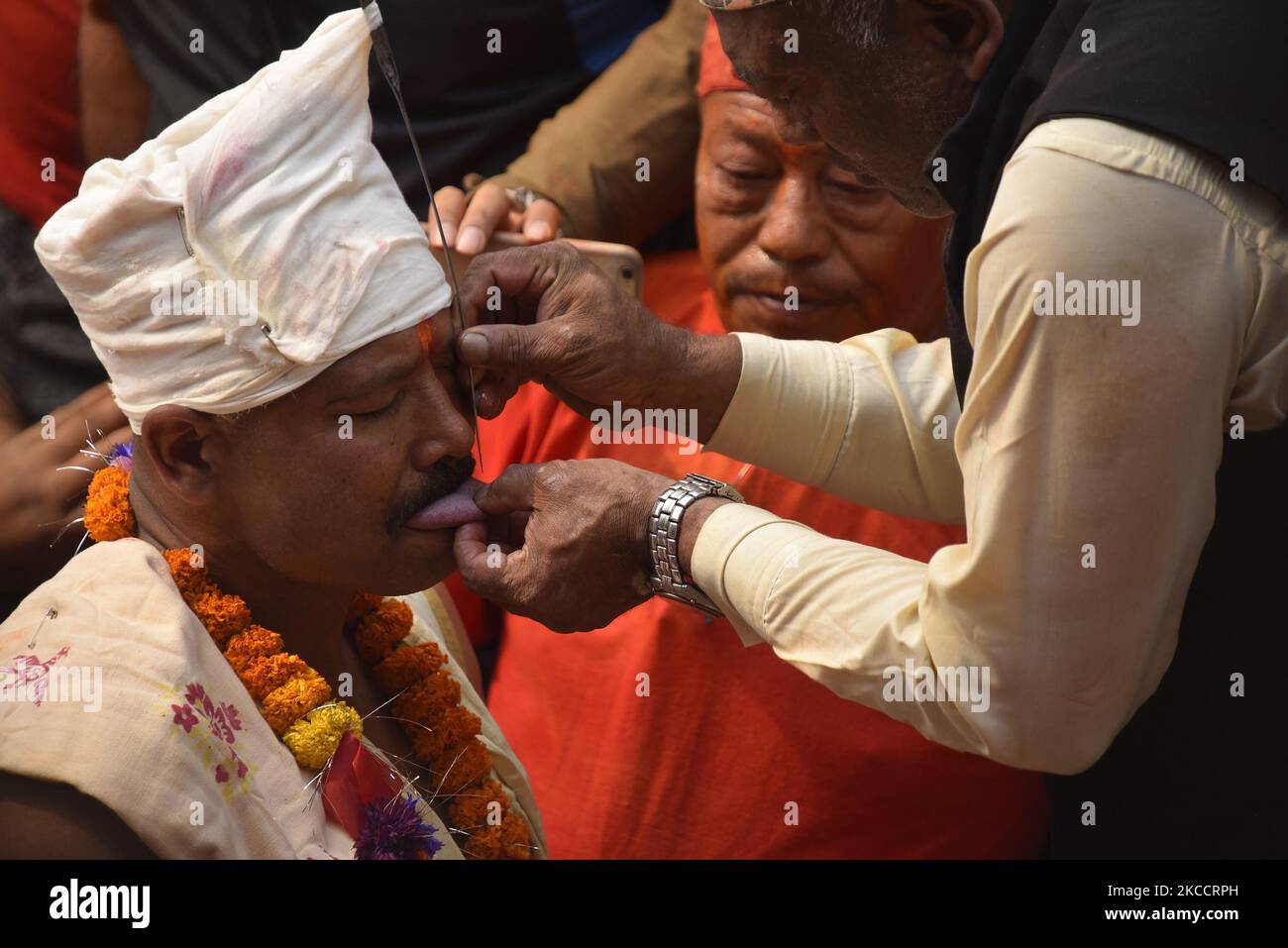 A priest tongue piercing 49 yrs old, Buddha Krishna Shrestha by an iron ...