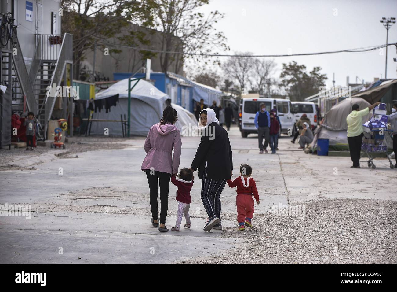 Refugees walk at Eleonas refugee camp in Athens, Friday, April 16, 2021 ...