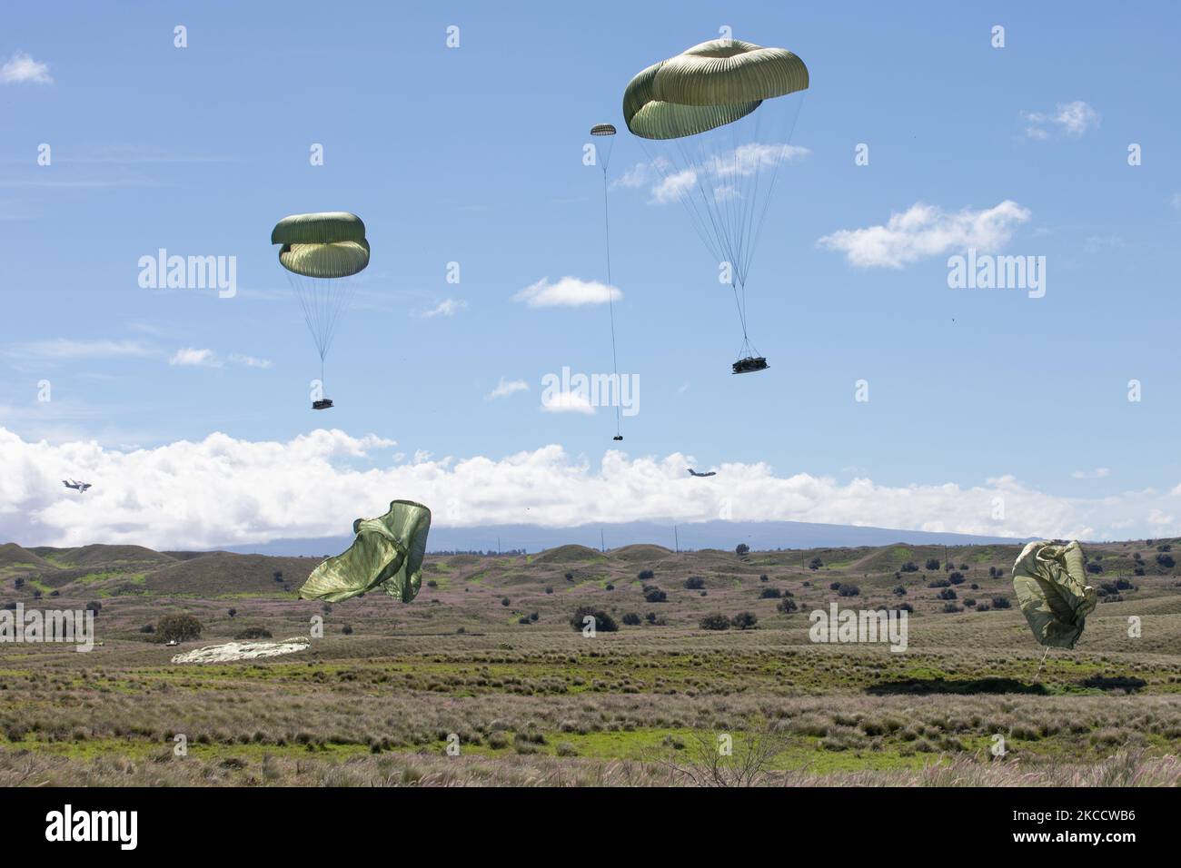 U.S. Air Force C-130s conduct an airdrop on Pohakuloa Training Grounds ...