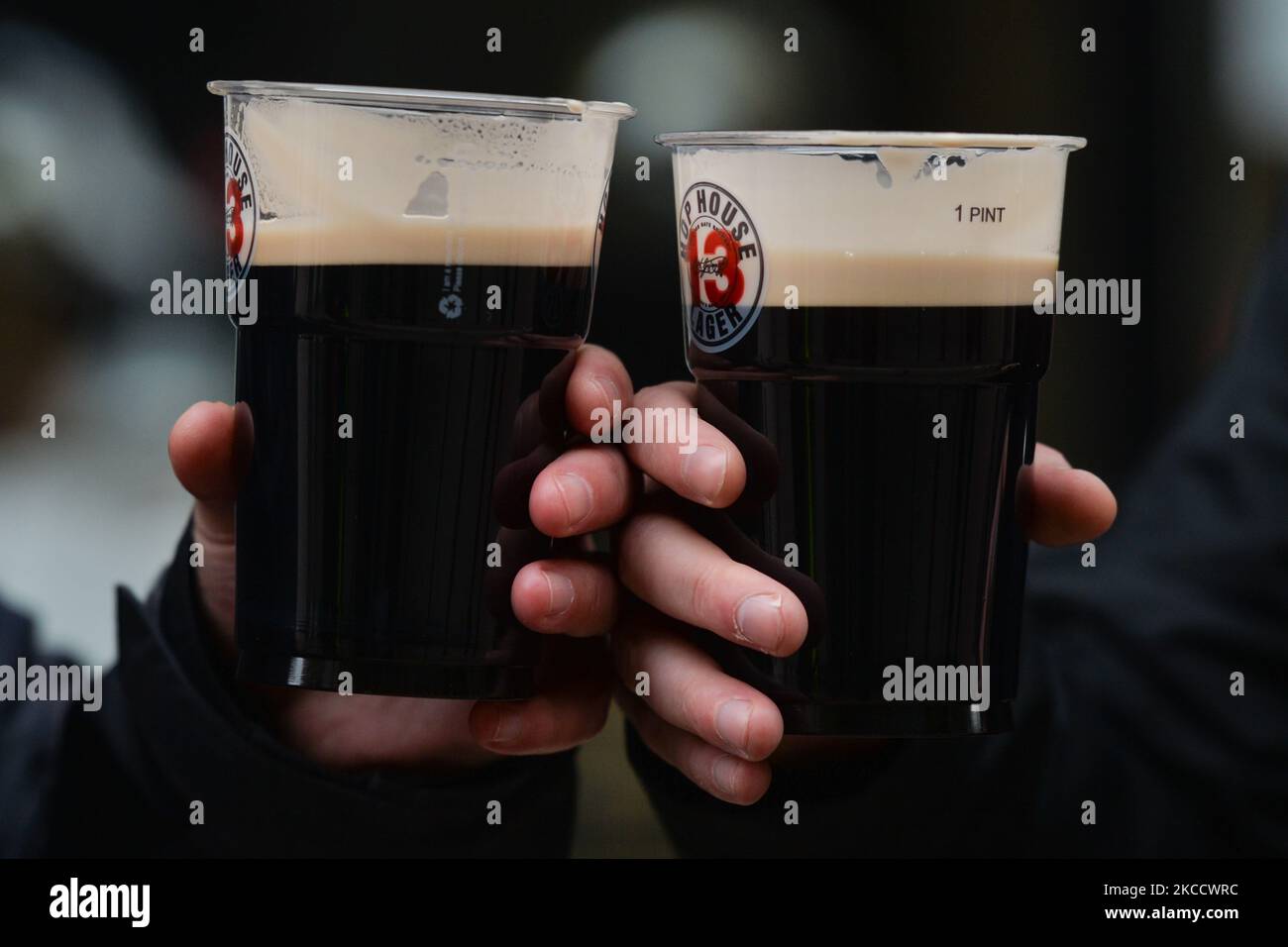 People are enjoying take-away Guinness beer in Hop House Lager plastic ...