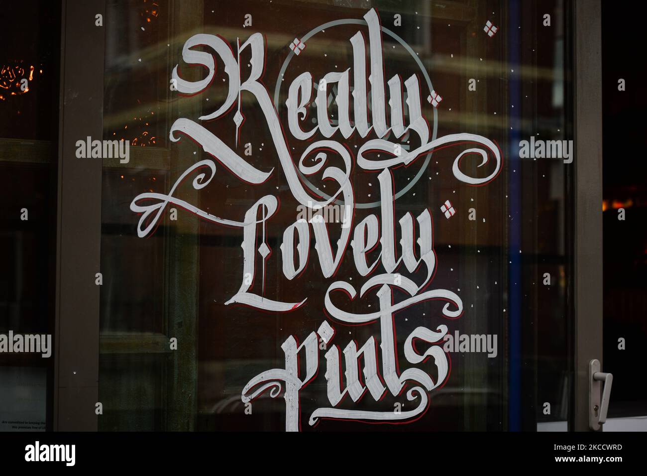 An inscription reading 'Really Lovely Pints' seen on the window of a ...