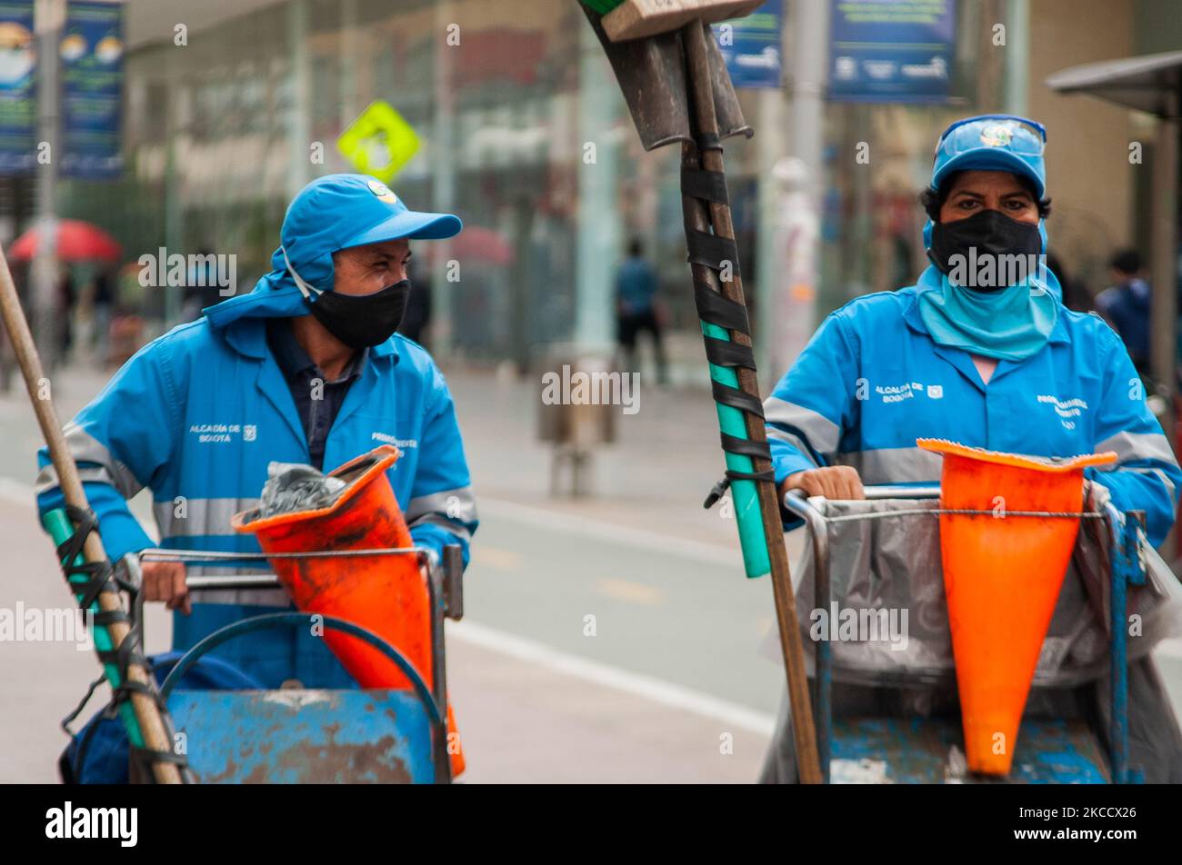 Workers from city cleaning chat while working while the city of Bogota ...