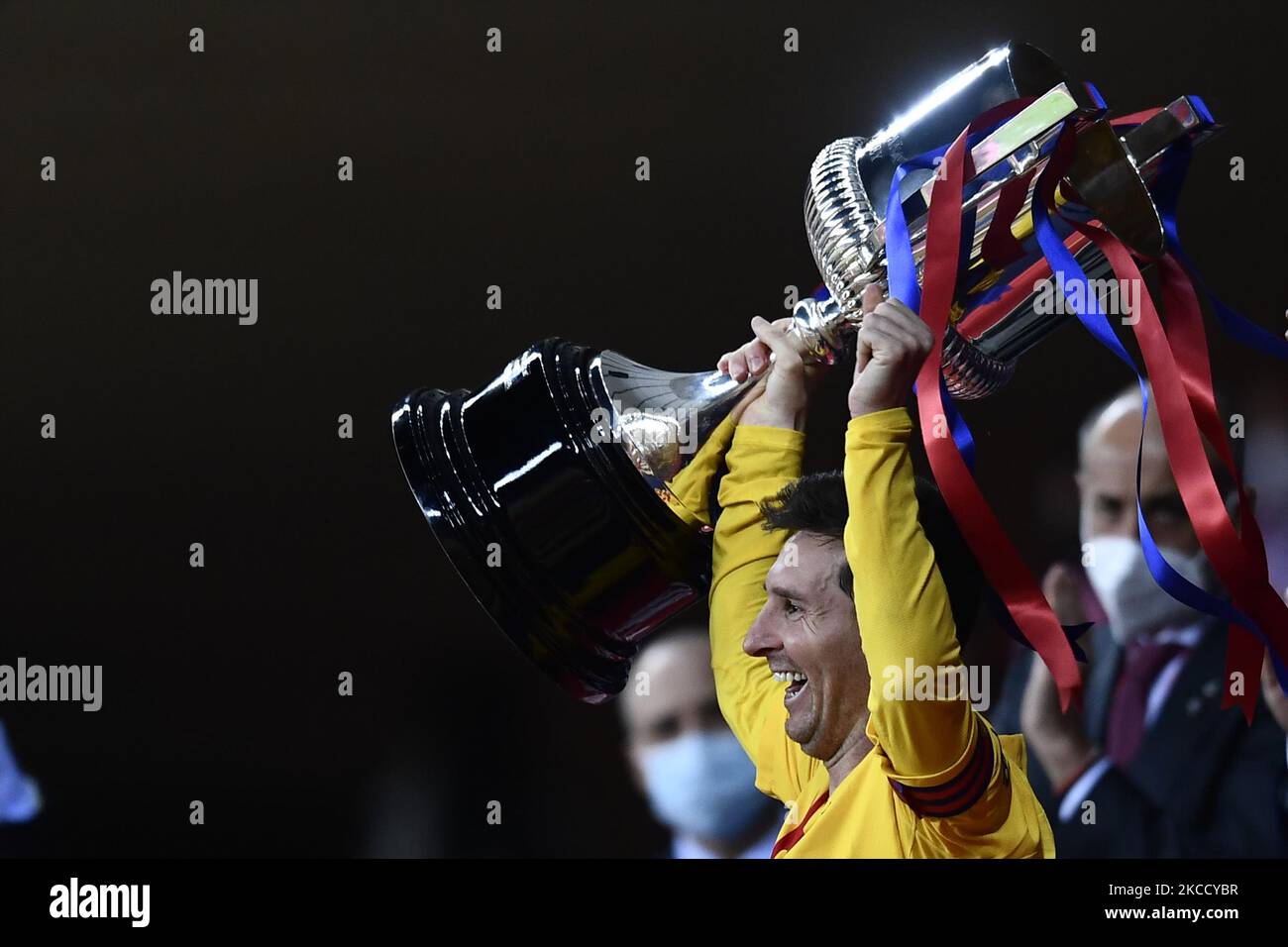 Lionel Messi of Barcelona lifts the trophy after winning with his team ...