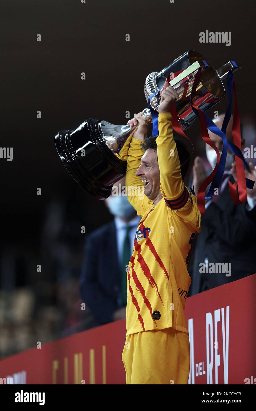 Lionel Messi of Barcelona lifts the trophy after winning with his team ...