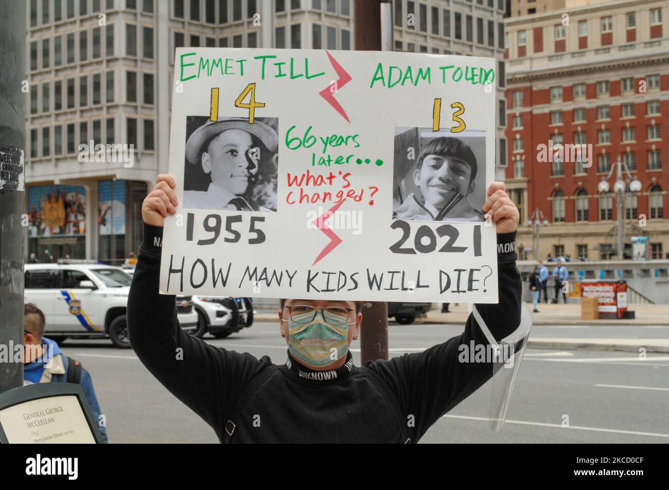 A protester connects the murder of Emit Till to the killing of 13-year ...