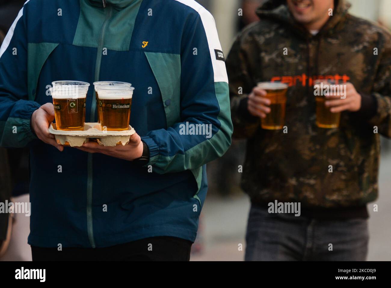 People carry takeaway pints in Dublin city center, during the COVID-19 ...