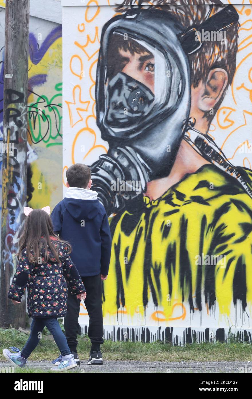 Two young kids look at a new mural by CHELS (Chelsea Jacobs, an ...