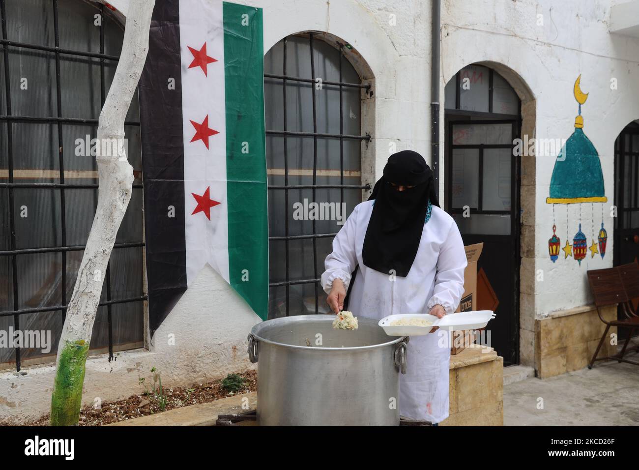 Syrian woman prepare meals for distribution to the poor in Idlib, Syria ...